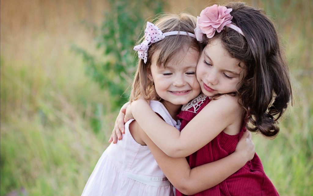 Cute sisters hugging